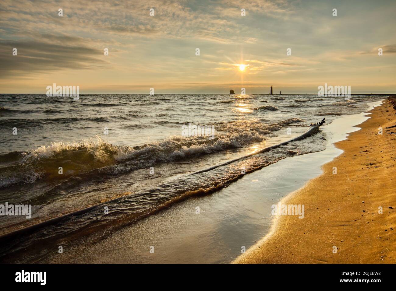 Shoreline of Lake Michigan and distant Grand Haven Lighthouse and pier ...