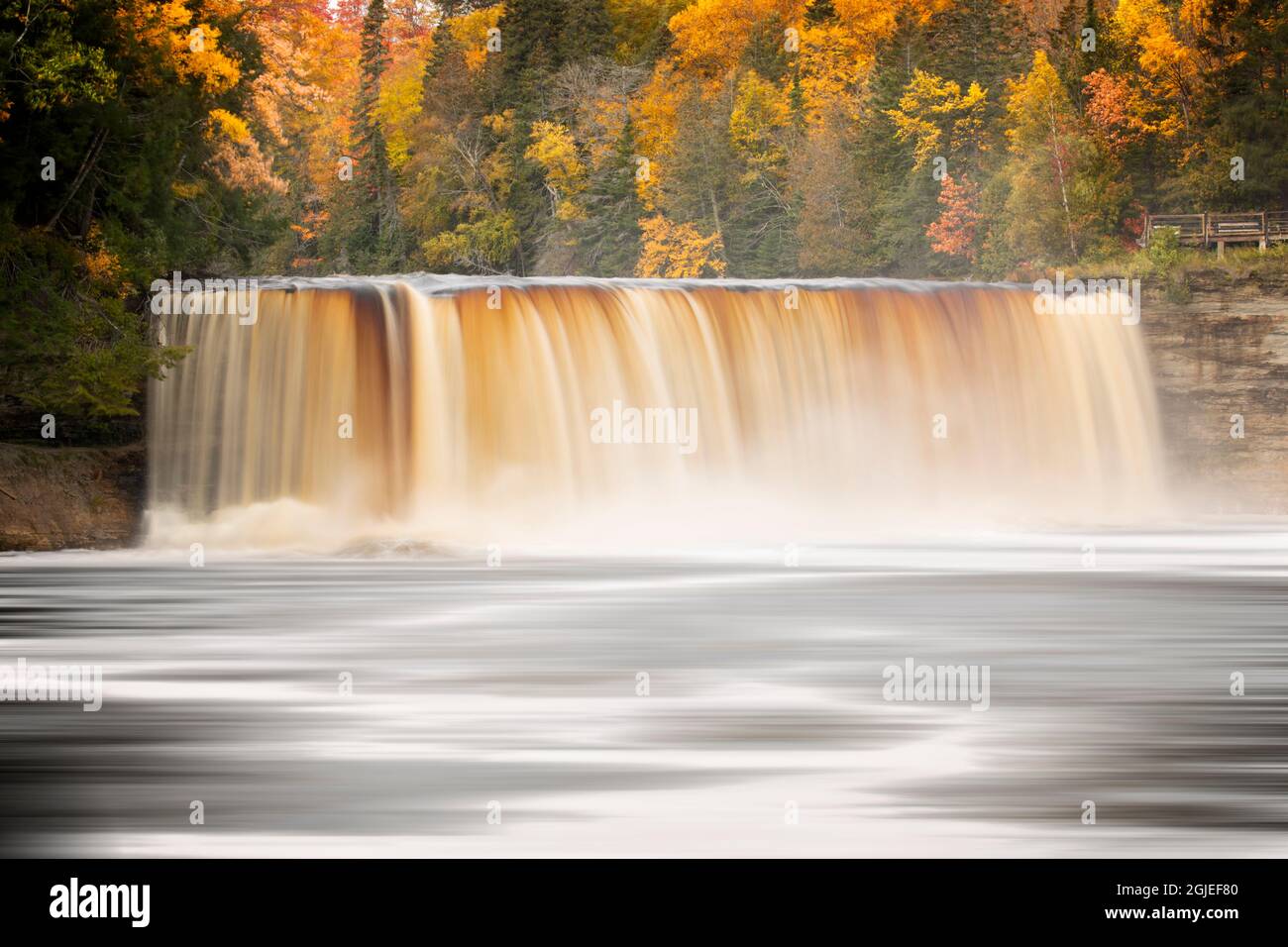 Low angle view of Tahquamenon Falls and fall foliage along Tahquamenon ...