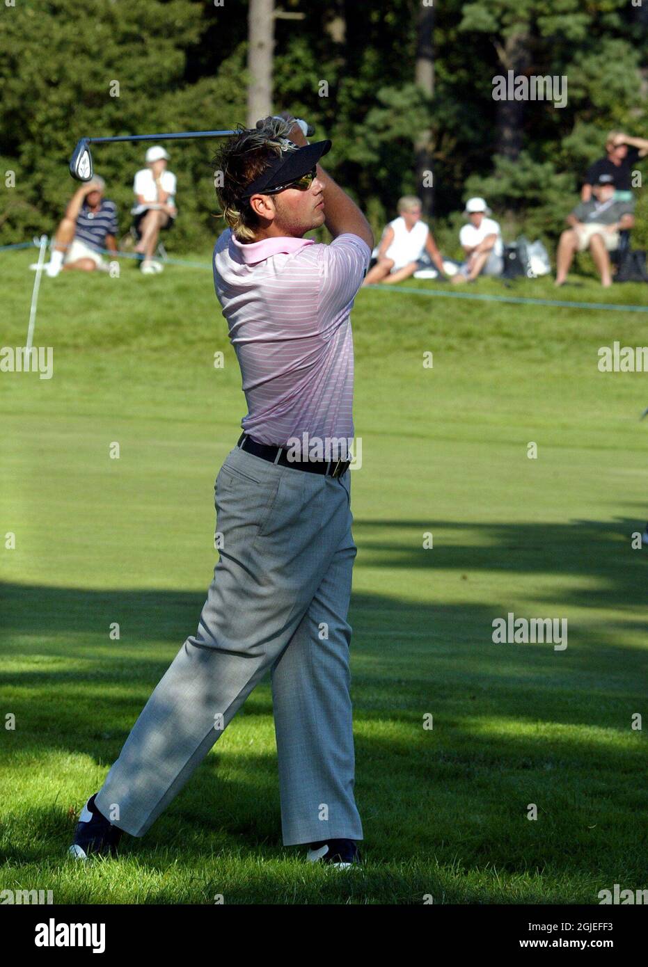 England's Nick Doherty watches as his ball travels down the fairway ...