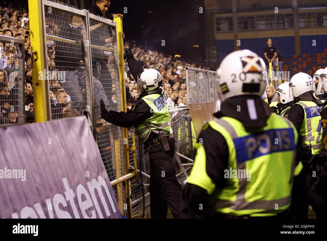 Riot police try to control a crowd of hooligans at the derby match ...