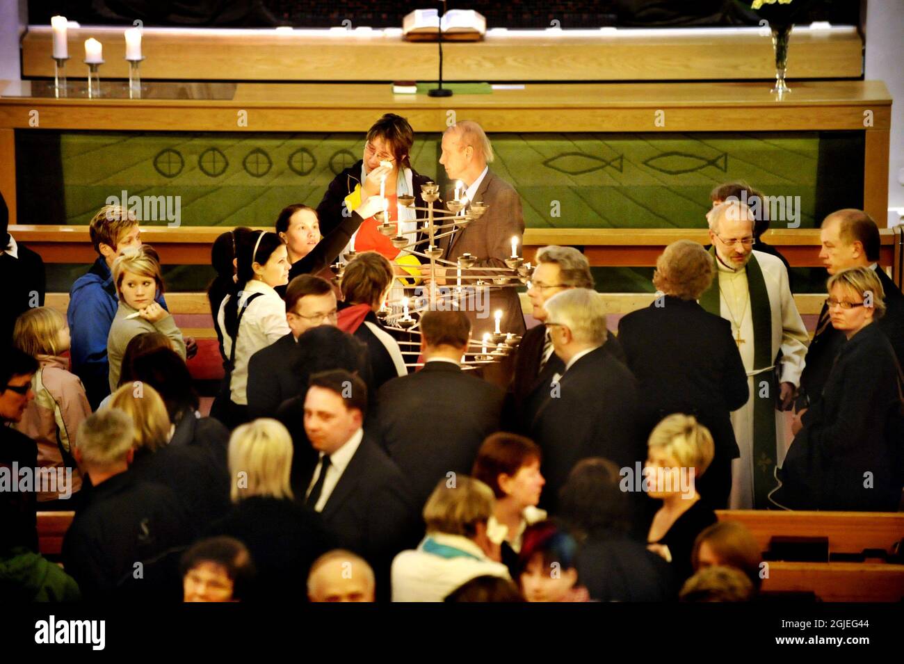 Mourners are seen during a memorial service in the church of the city ...