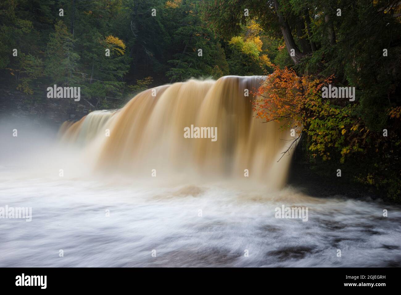 USA, Michigan. Fall colors at Presque Isle River waterfall on the south ...