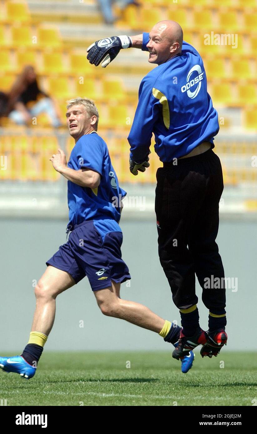 Sweden goalkeeper Magnus Hedman (r) palms away a shot from Marcus ...