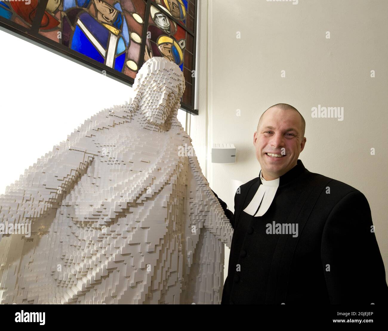 Rev. Per Wilder poses with a statue of Jesus Christ made entirely out ...