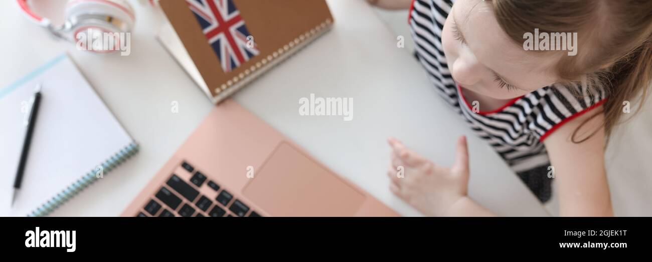 Little girl learns foreign languages on laptop Stock Photo - Alamy