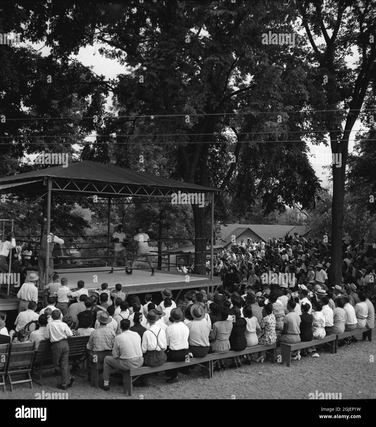 Joe Louis, American boxer, training in front of numerous spectators ...