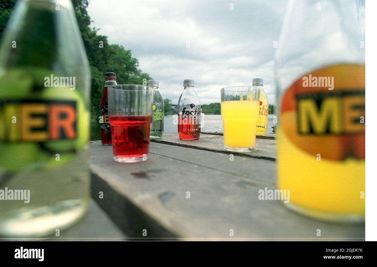 Bottles and glasses filled with the soft drinks Mer and Festis Stock ...
