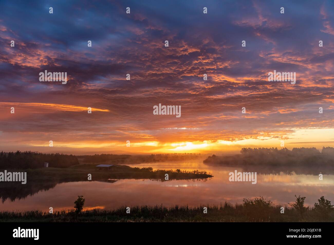 Amazing sunrise clouds over small lake at Cub Creek Recreation Area ...