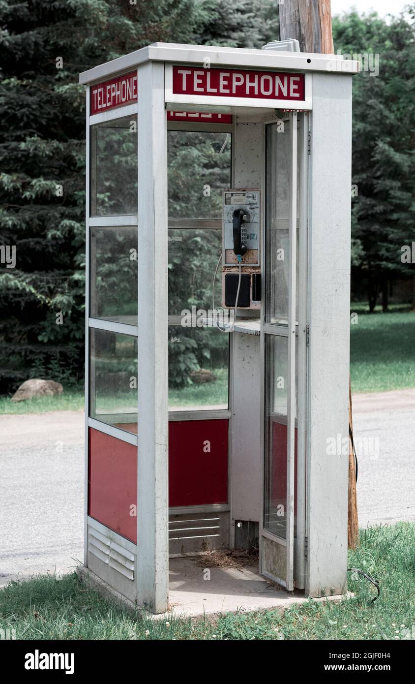 USA, New York State, Adirondack Region. Pay telephone booth in a rural ...