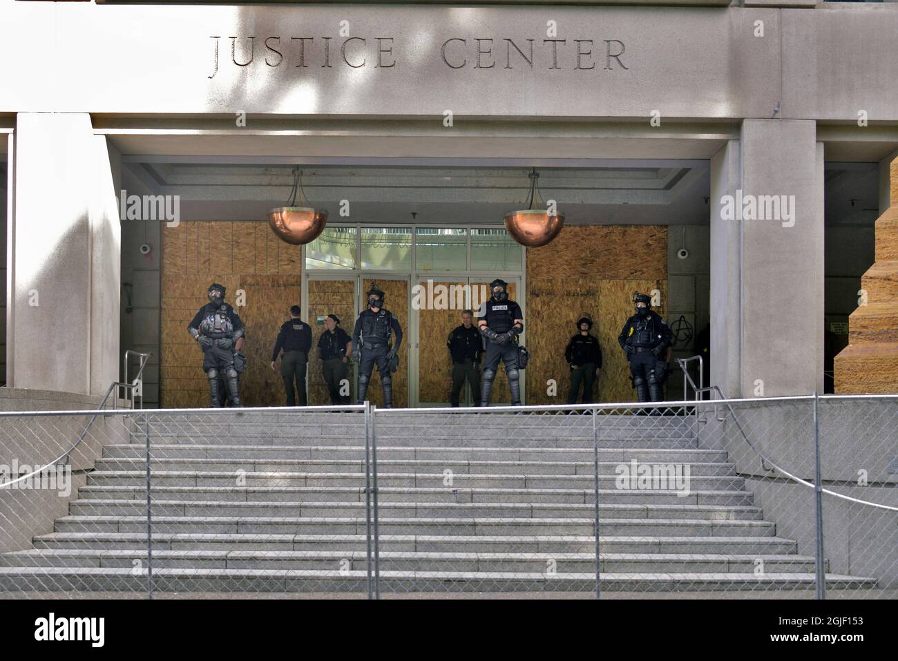 USA, Oregon, Portland. Police protecting Justice Center building during ...