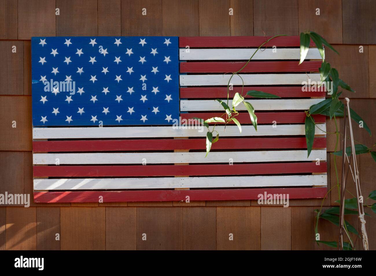 Close-up of American flag made from wood slats on residential cedar ...