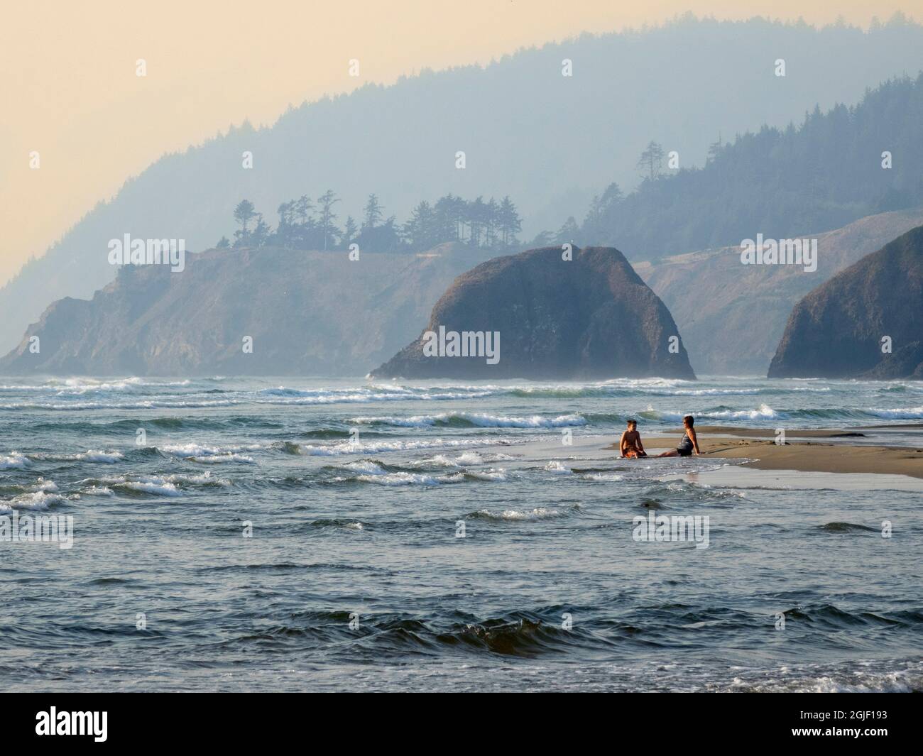 Oregon, Cannon Beach. Relaxing at shoreline. (Editorial Use Only Stock ...
