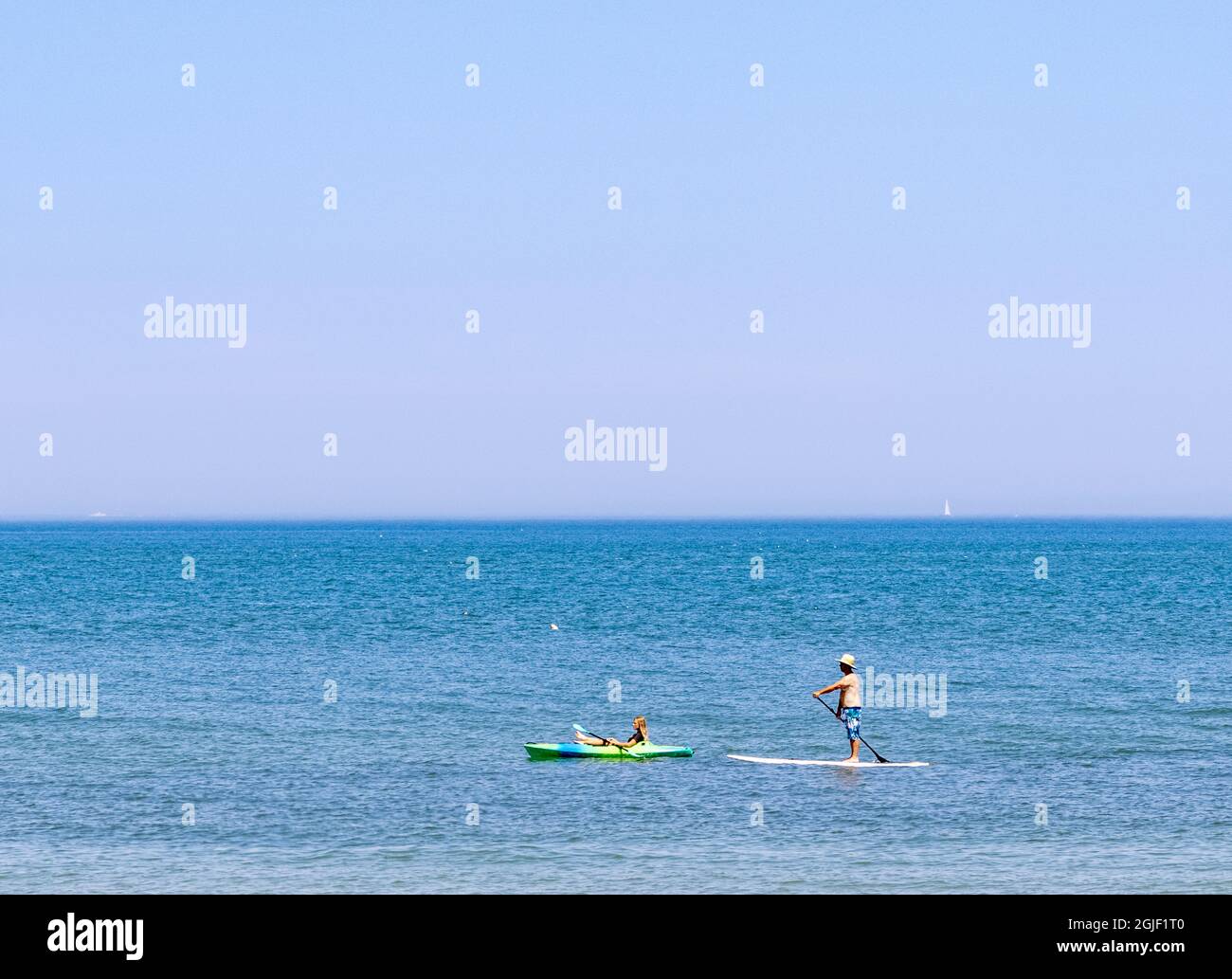 Couple paddling boarding and kayaking off Gin Beach in Montauk, NY ...