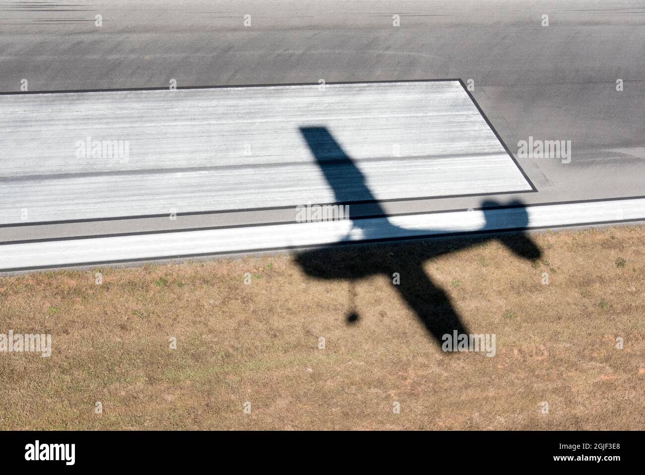 USA, Tennessee. Aerial. Shadow of airplane on runway just before ...