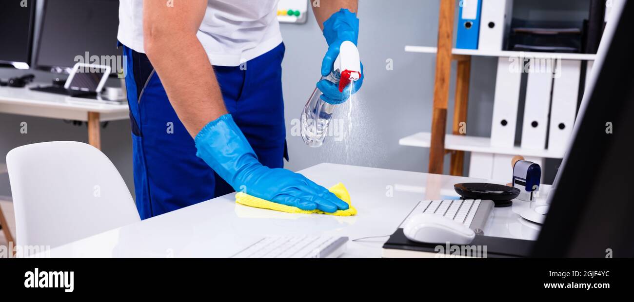 Office Cleaning Service. Janitor Spraying Desk. Workplace Hygiene Stock ...