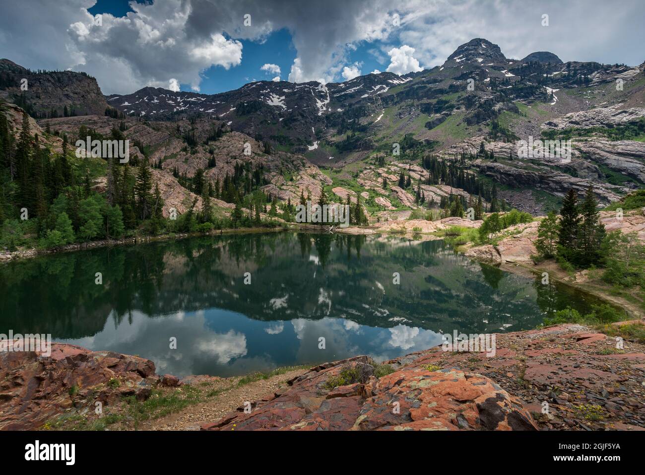 Quartzite rock and reflection of Dromedary Peak in Lake Florence near ...