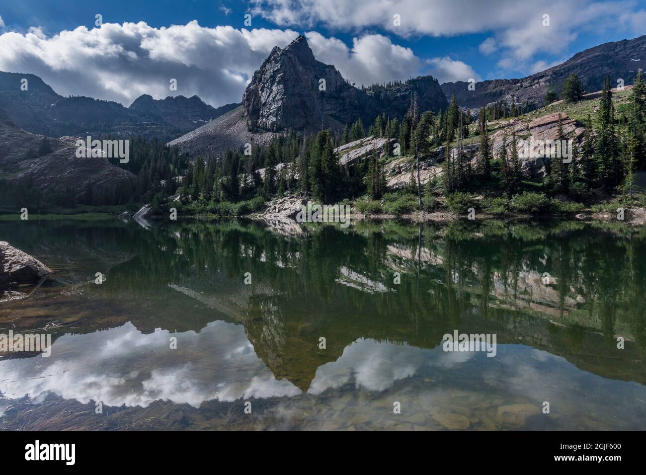Sundial Peak and clouds reflected in Lake Blanche is an icon of Wasatch ...