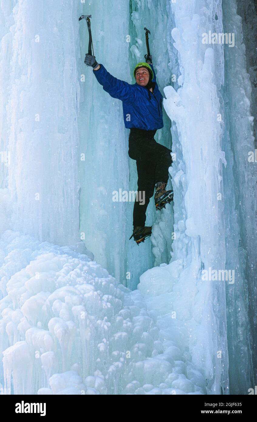 Man extending ice axe while ice climbing in cave, Utah Stock Photo - Alamy
