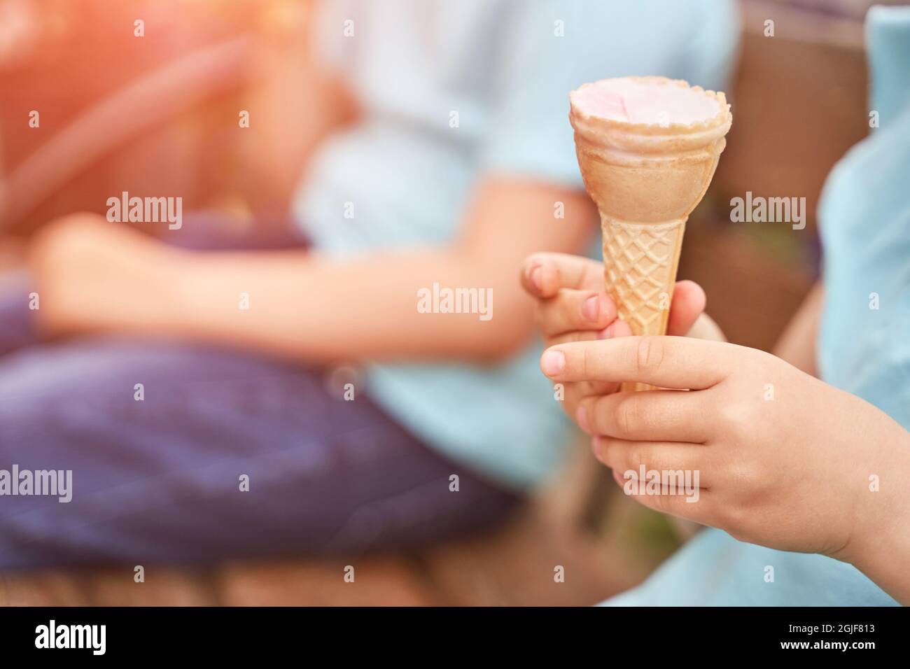 Pretty fun kid eating ice cream at park. Vacation concept. Staycation ...