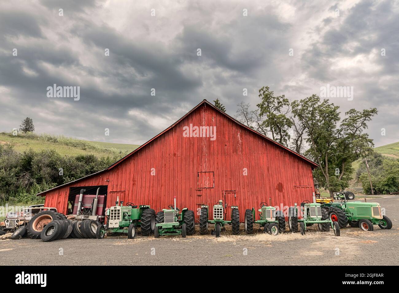Old antique tractors lined up in front of red barn, Palouse ...