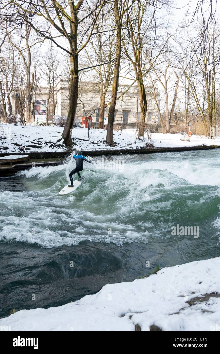 Surfer riding upstream wave in the Eisbach river in Munich, Germany ...