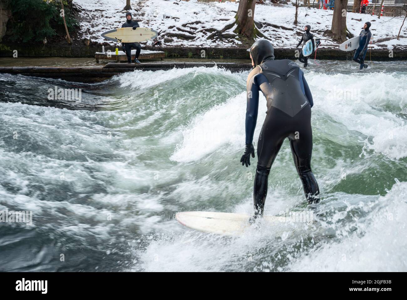 Surfer riding upstream wave in the Eisbach river in Munich, Germany ...