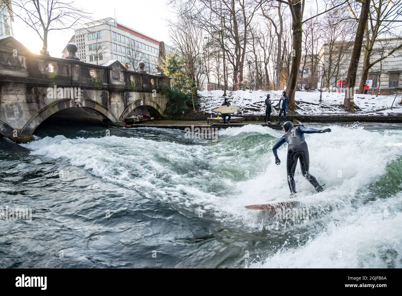 Surfer riding upstream wave in the Eisbach river in Munich, Germany ...