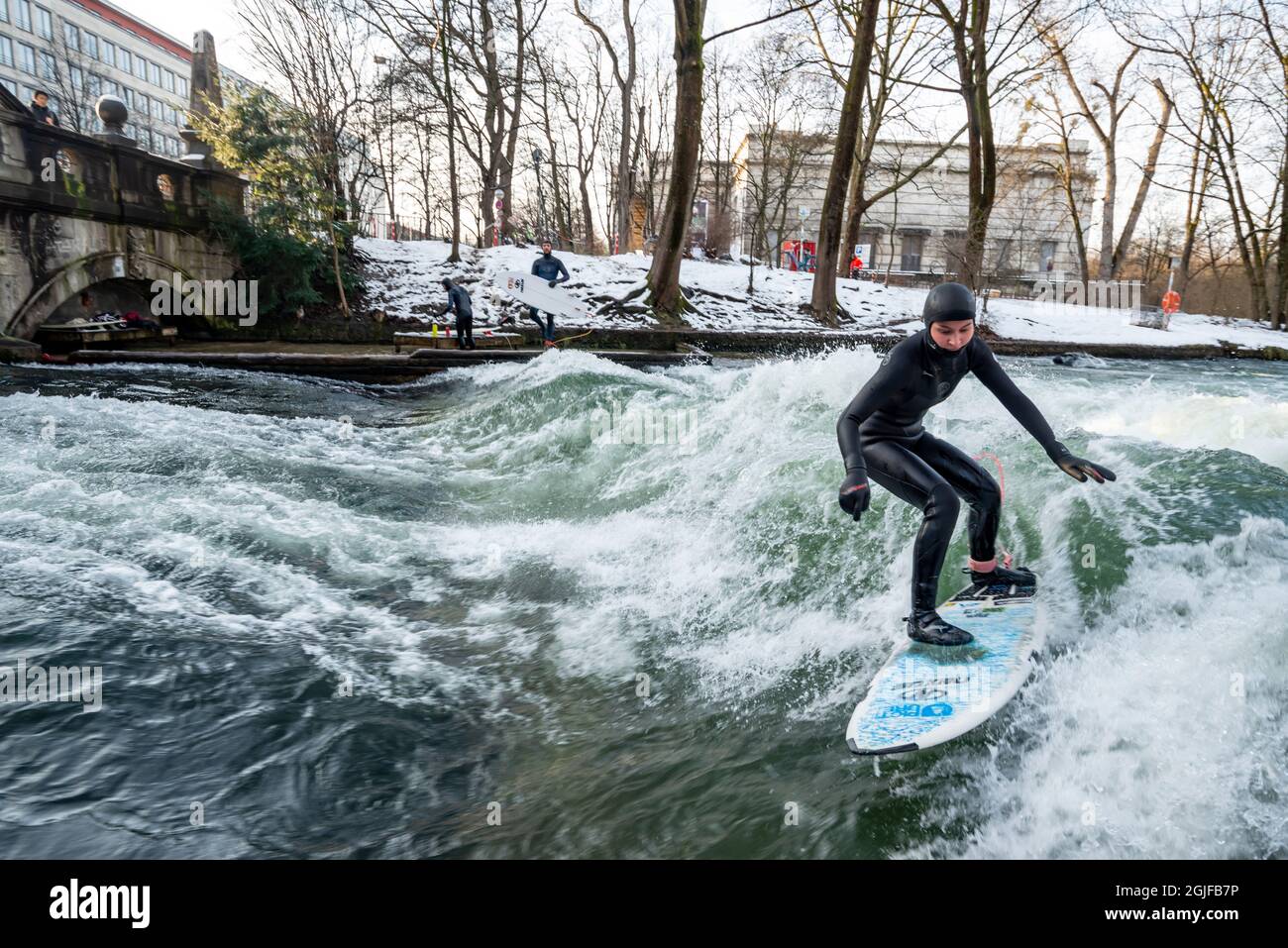Surfer riding upstream wave in the Eisbach river in Munich, Germany ...