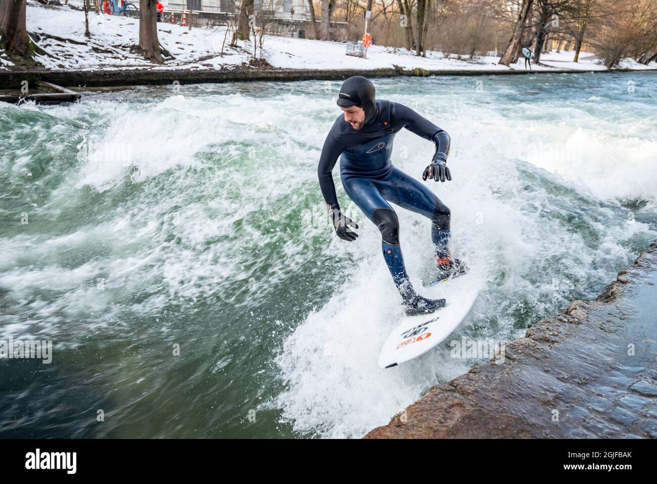 Surfer riding upstream wave in the Eisbach river in Munich, Germany ...