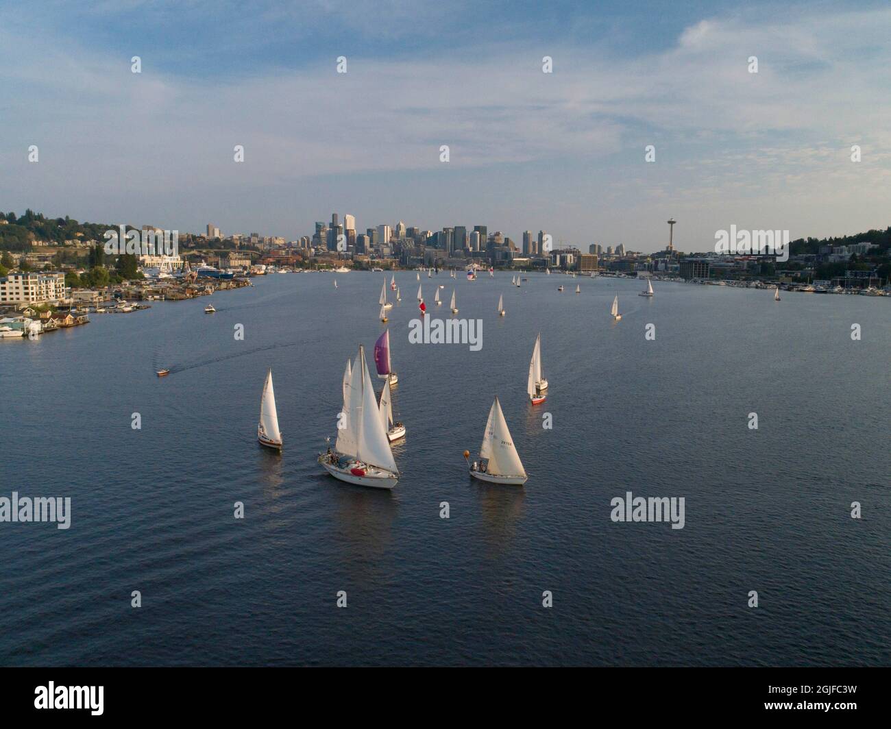 Aerial view of sailboats racing on Lake Union in the evening with the ...