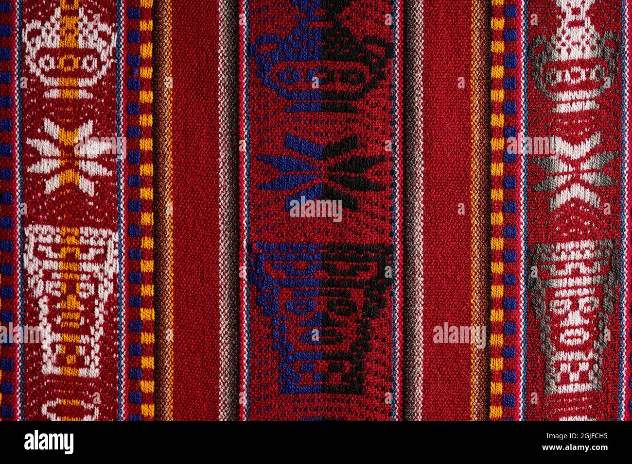 Closeup of red and blue tapestry fabric texture background wallpaper ...