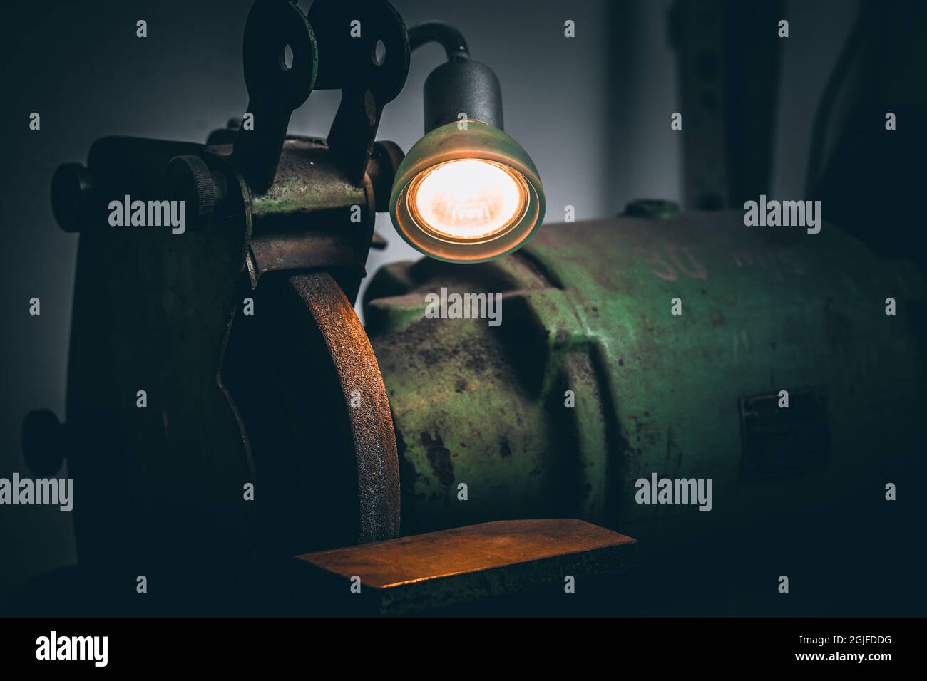 Green Electrical grinding machine. Industrial Bench Grinder in workshop ...