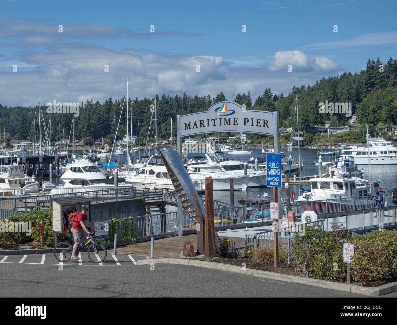 Usa, Washington State, Gig Harbor, man on bicycle near pier. (MR Stock Photo - Alamy