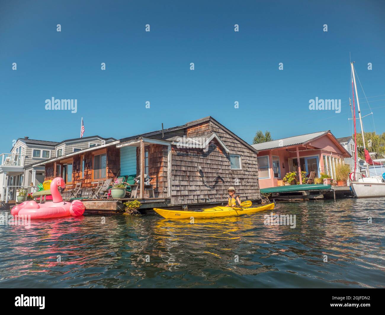 Usa, Washington State, Seattle, woman kayaking near floating homes on ...