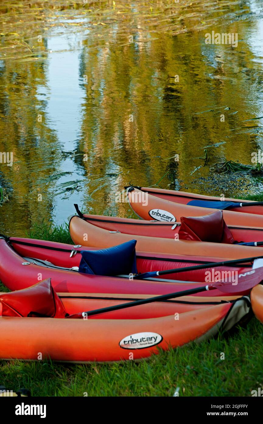 USA, Washington State, Woodinville. Red and orange kayaks alongside of ...
