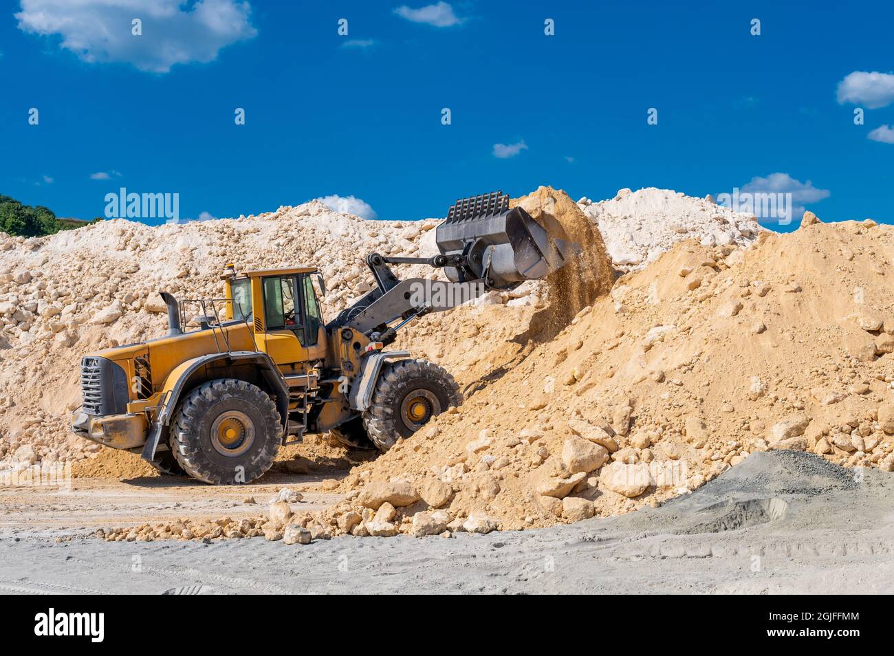 Front end loader and limestone pile Stock Photo - Alamy