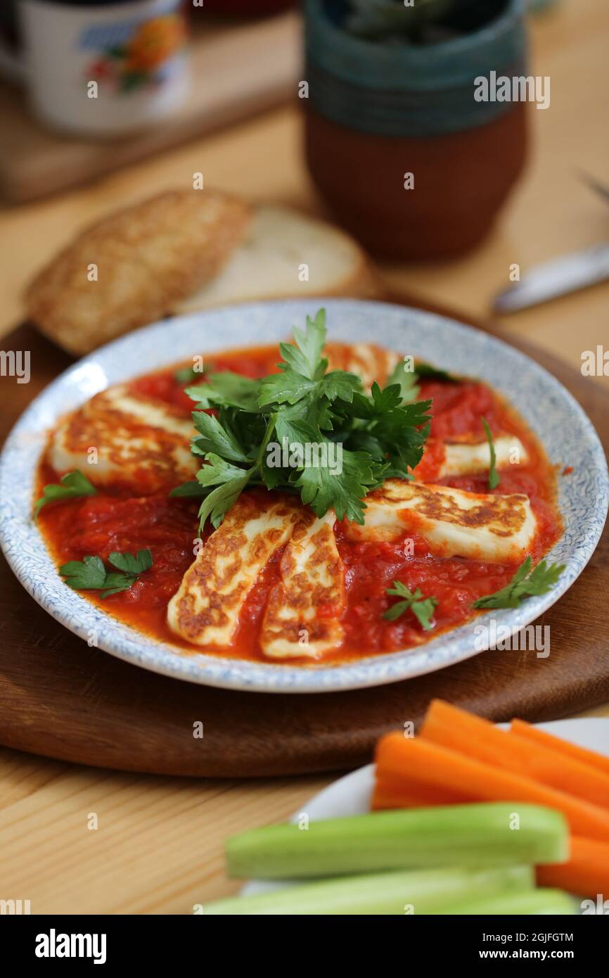 fried halloumi on a bed of tomato sauce Stock Photo - Alamy