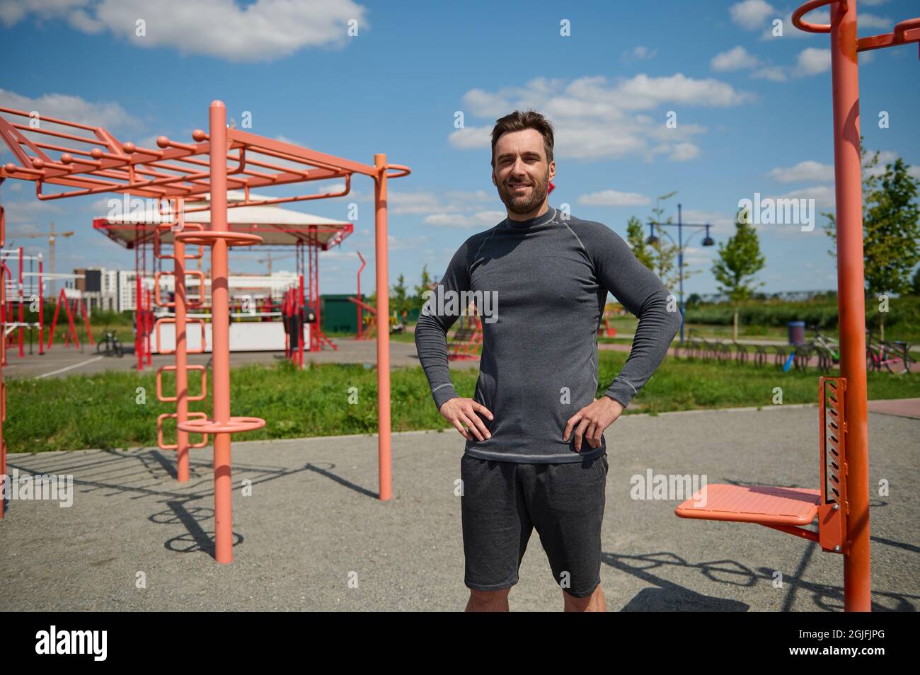 Confident portrait of a handsome European sportsman athlete standing on ...