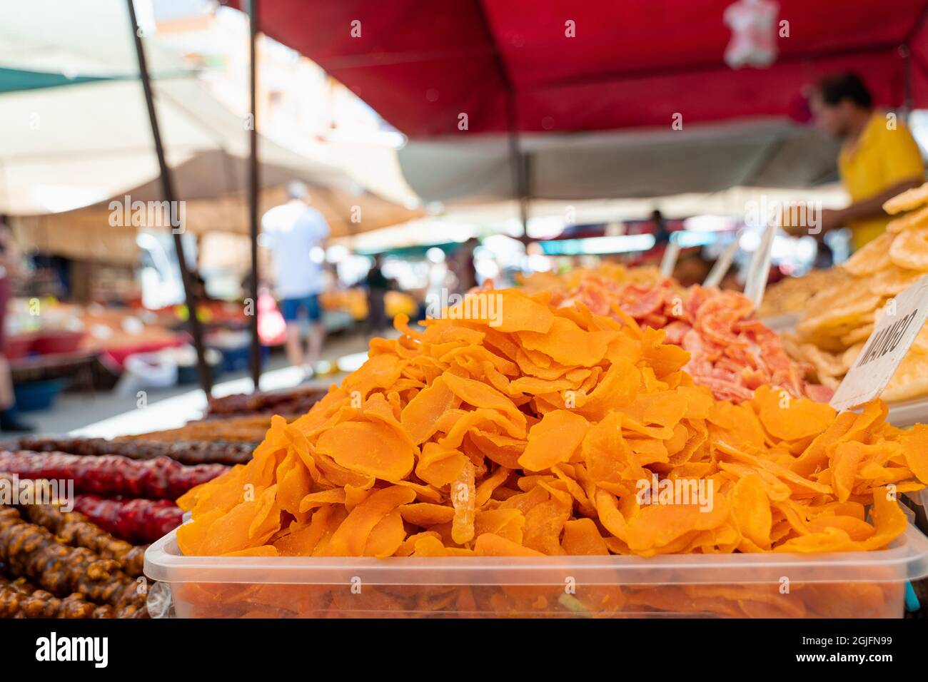 Dried mango on background of market. Dried candied fruits sold in ...