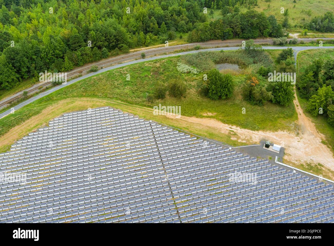 Amazing aerial view of solar panels stand in a row in green energy ...