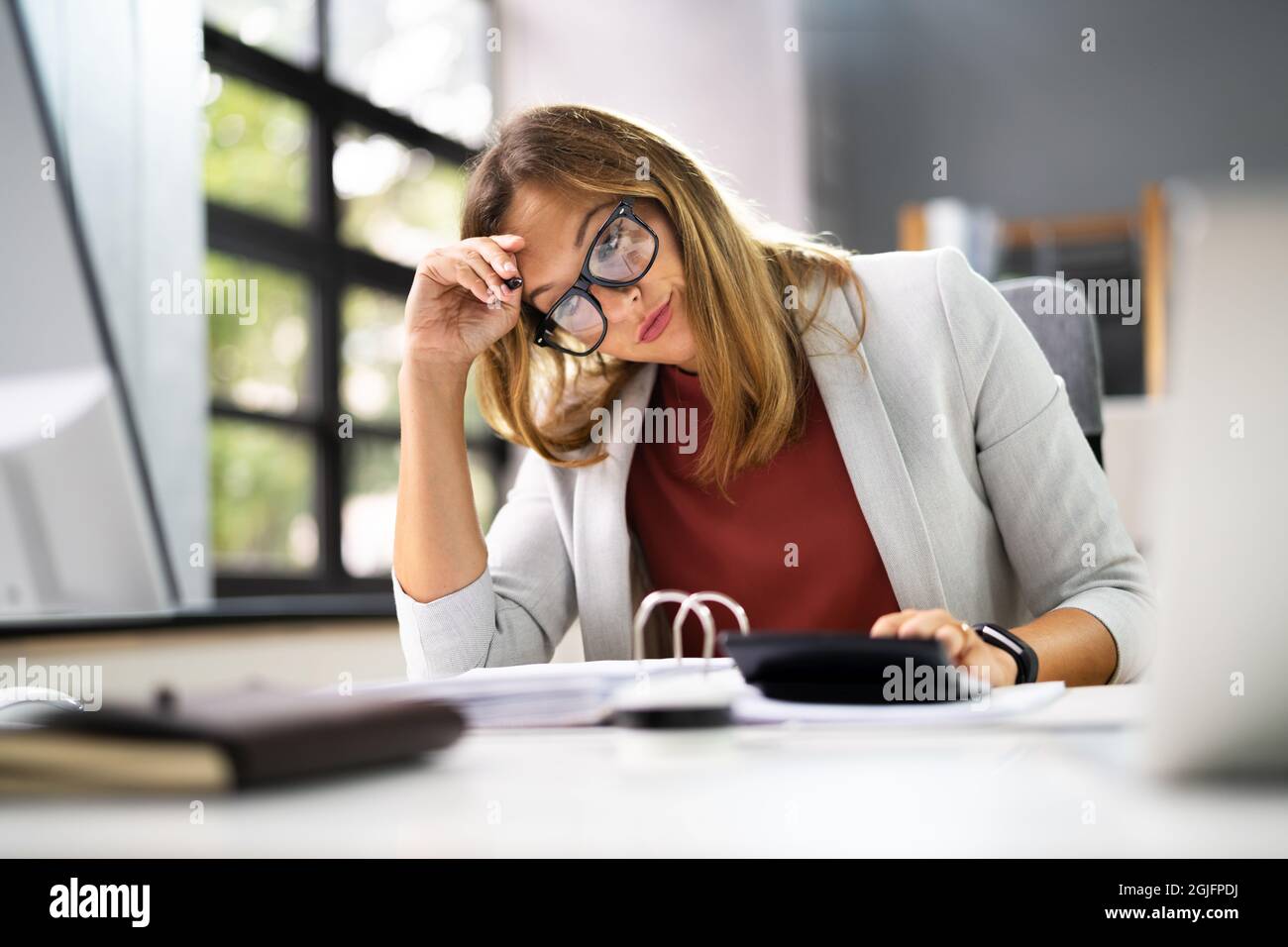 Stressed Accountant Woman With Headache In Office Stock Photo - Alamy