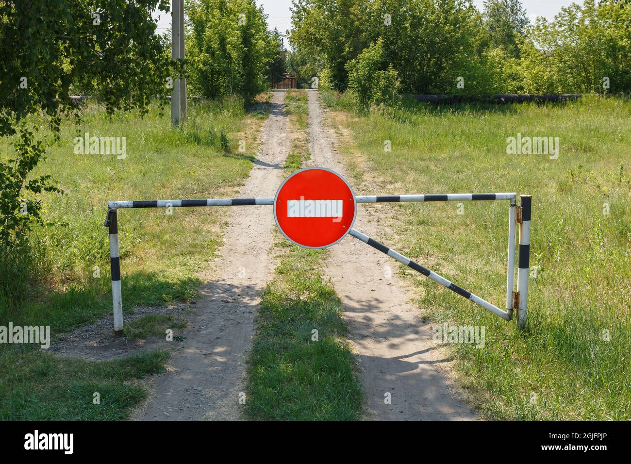 Closed barrier and prohibition sign on a rural road. No entry Stock ...