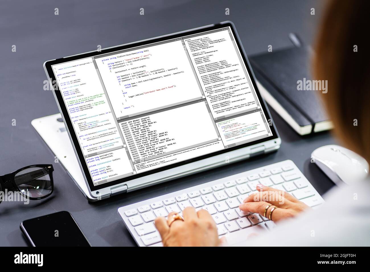 Programmer Or Coder At Office Desk Using Laptop Stock Photo - Alamy