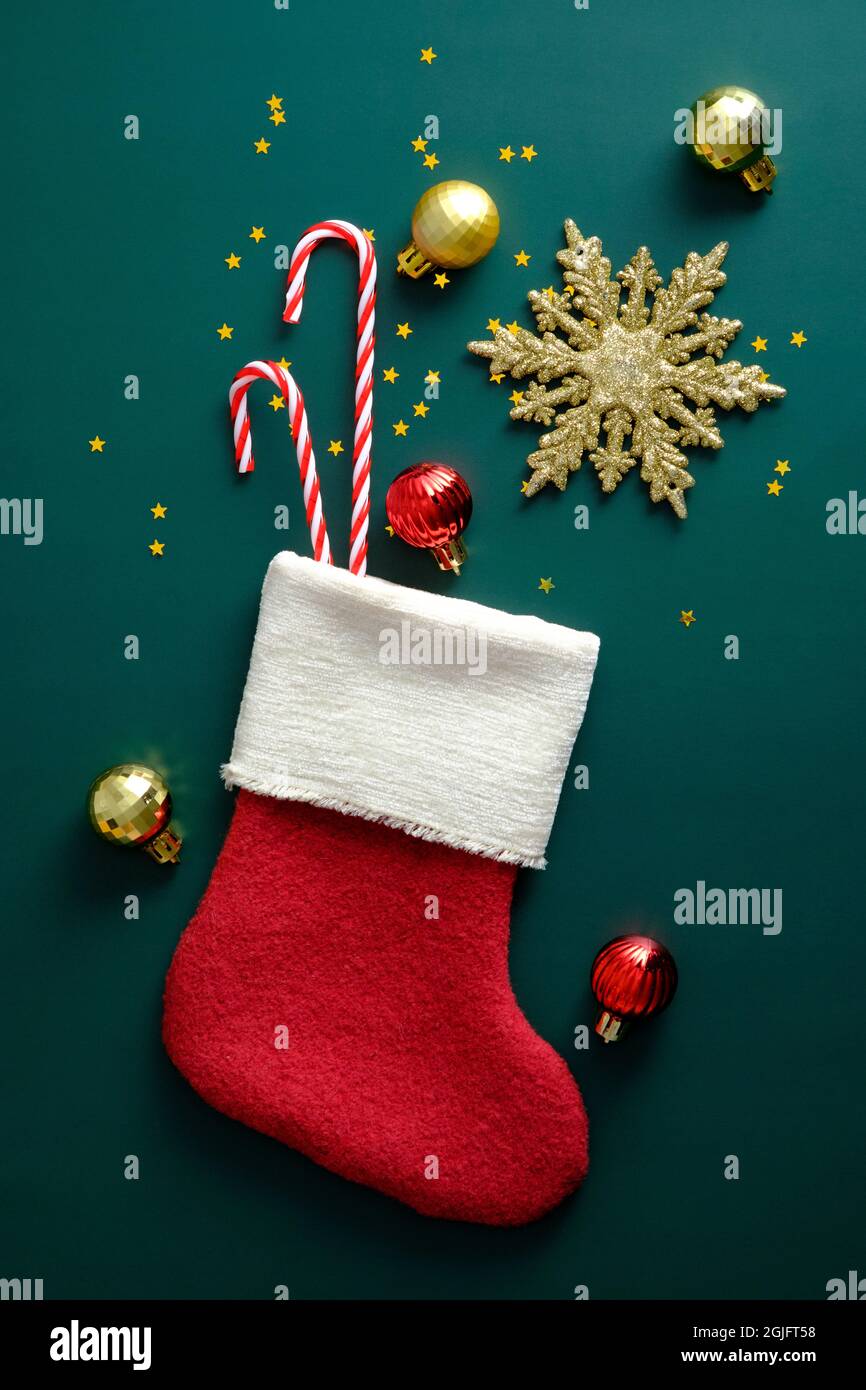 Red Santa Stocking with candy canes, golden balls, snowflake on green ...