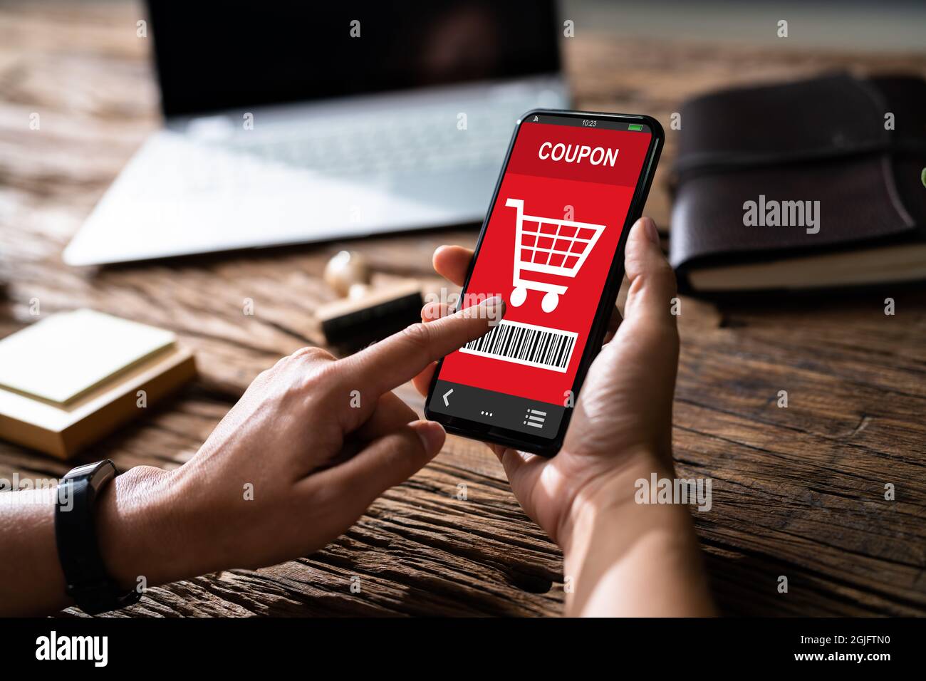 Woman's Hand Holding Mobile Phone With Shopping Coupon Stock Photo - Alamy