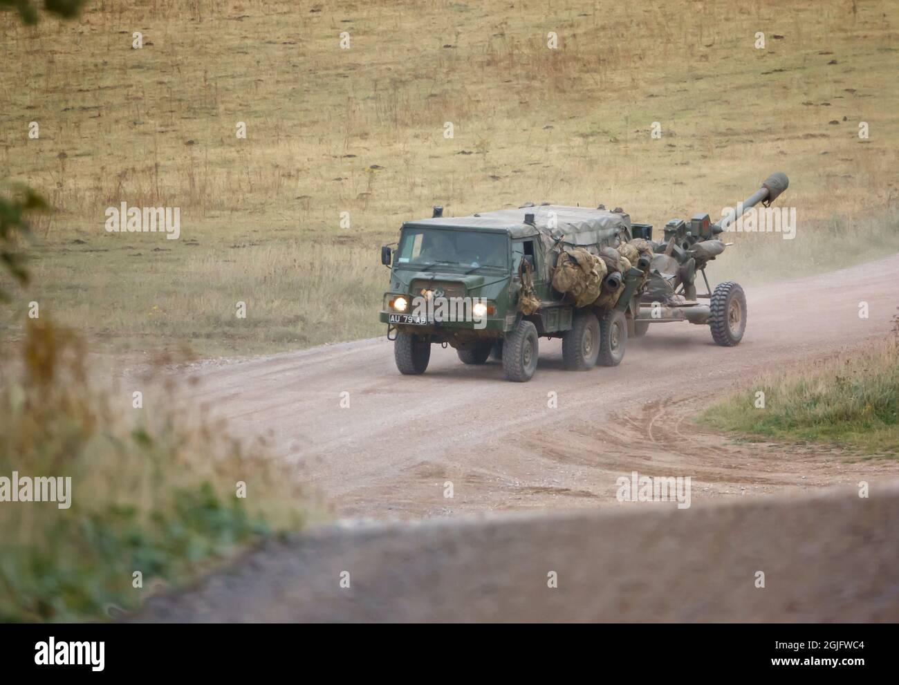 British army Steyr-Daimler-Puch BAE Systems Pinzgauer high-mobility 6x6 all-terrain vehicle tows ...