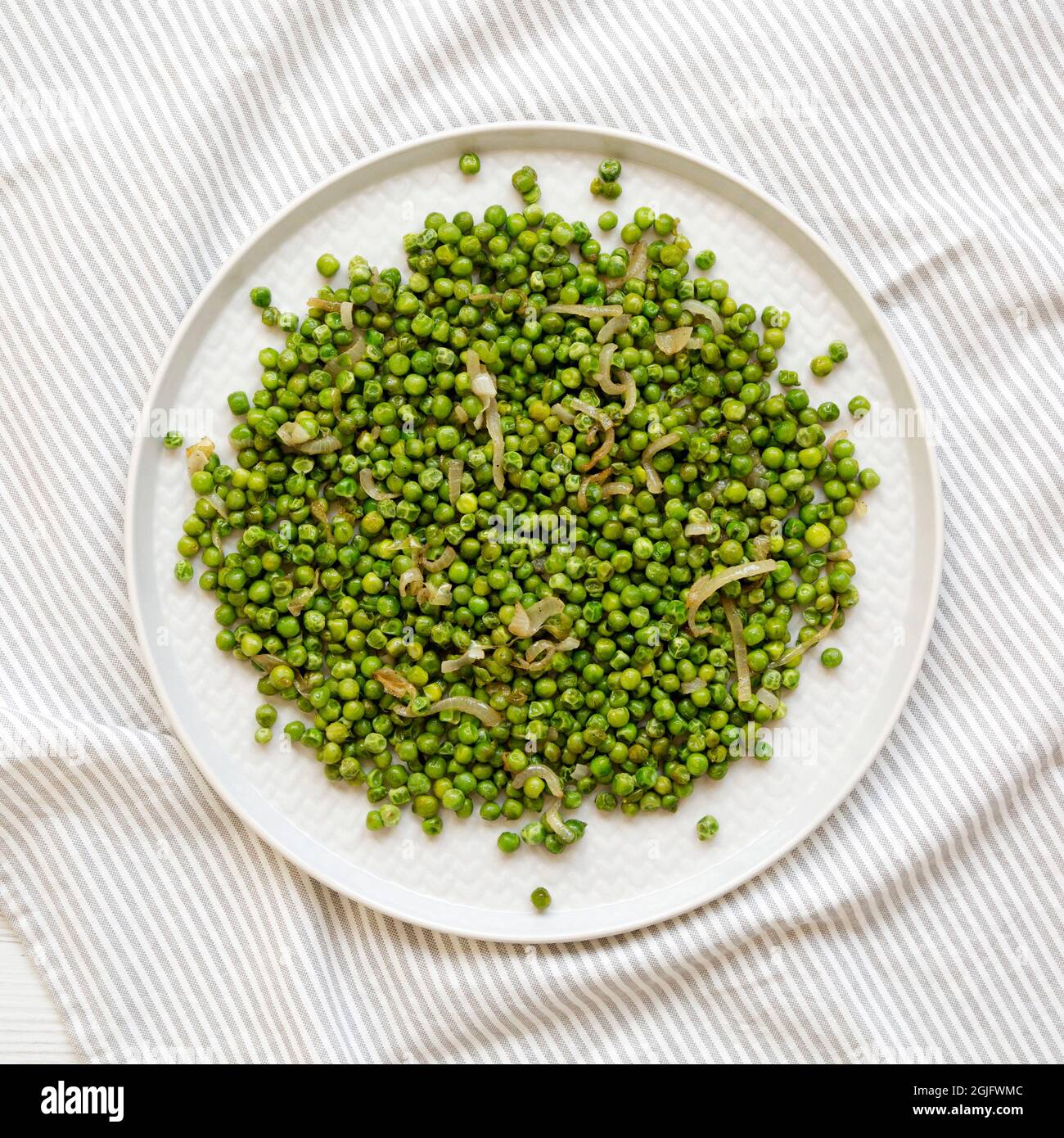 Homemade Sauteed Green Peas on a plate, top view. Flat lay, overhead ...