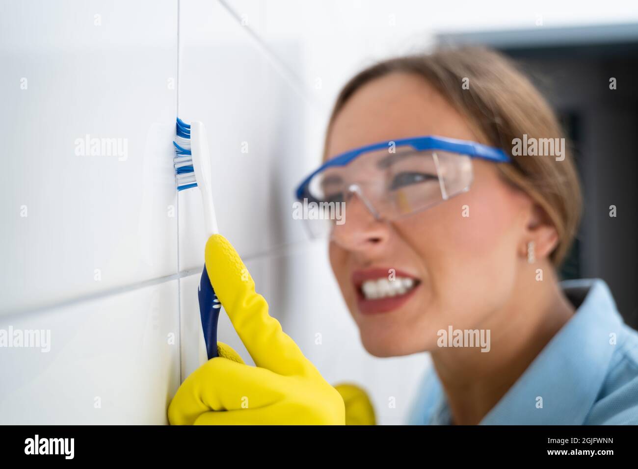 Cleaning Dirty Tile Grout In Bathroom Using Toothbrush Stock Photo - Alamy