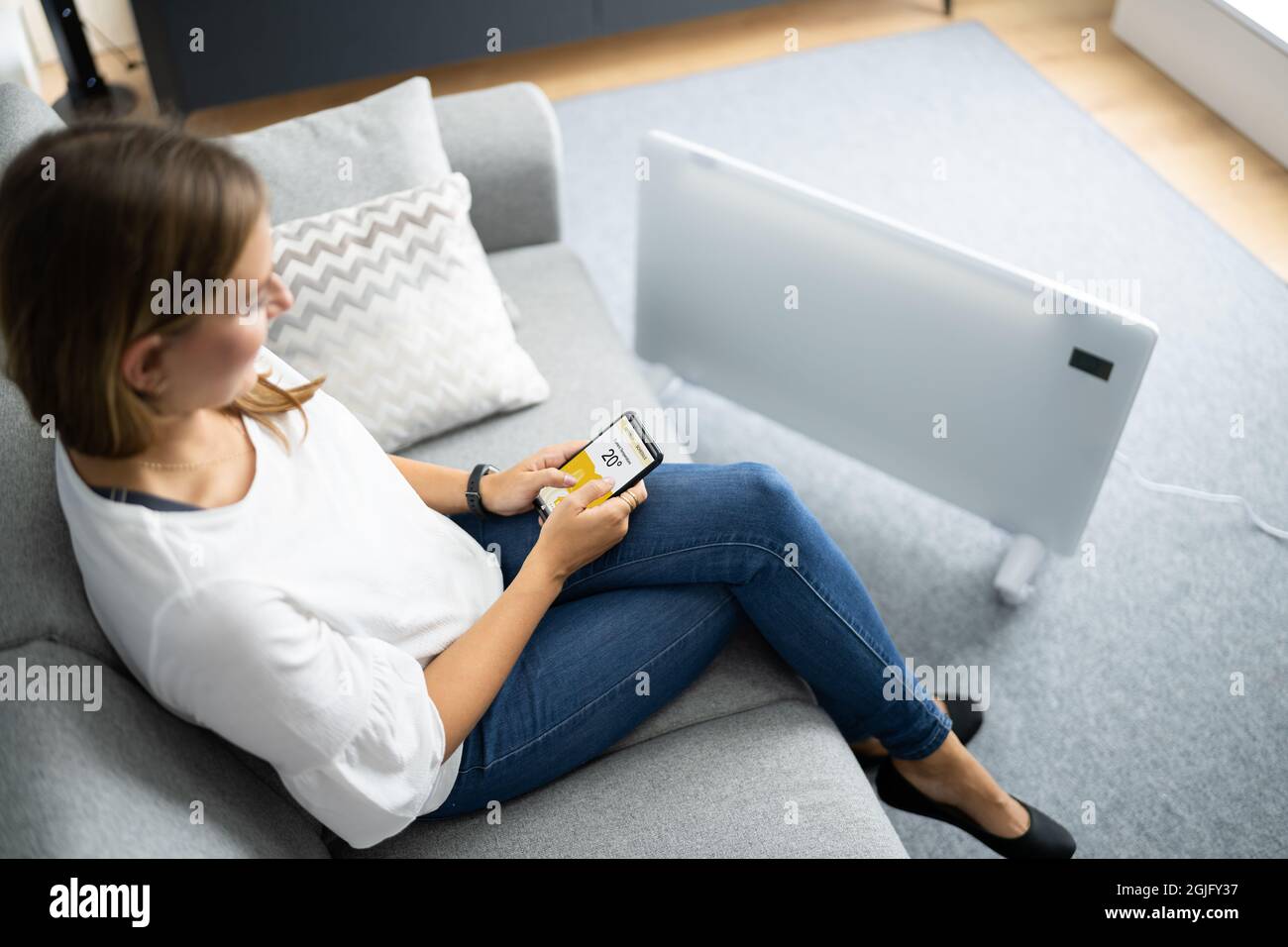 Happy Warm Woman Near Radiator With Heat Comfort Stock Photo - Alamy