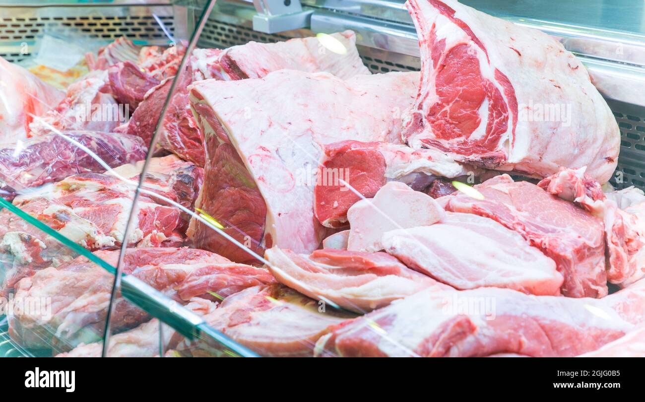 Pieces of meat in a butcher shop display Stock Photo - Alamy